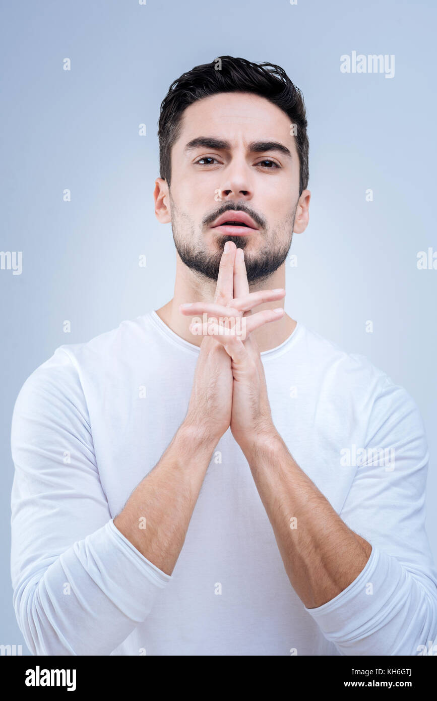 Young man feeling impressed while looking at the pictures in a gallery ...