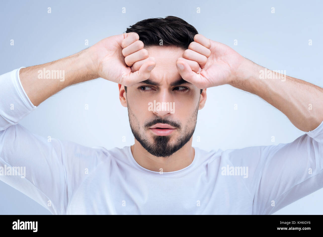 Young confident man having a suspicion about the strange situation at ...