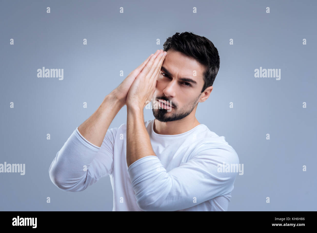 Young emotional man praying for the health of his close people Stock ...