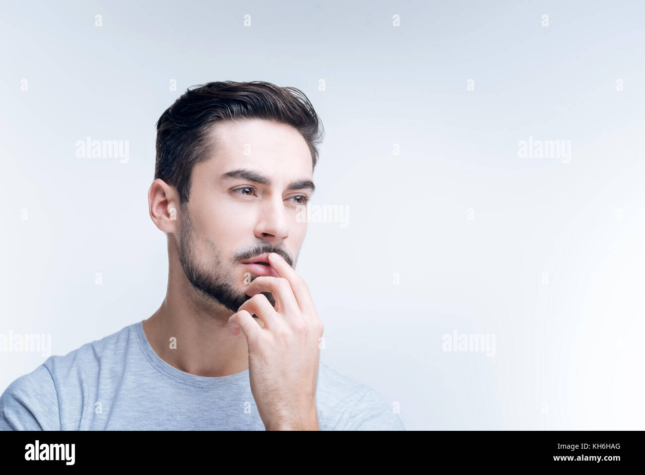 Concentrated young specialist sitting at work and thinking Stock Photo ... Concentrated young specialist sitting at work and thinking Stock Photo ...