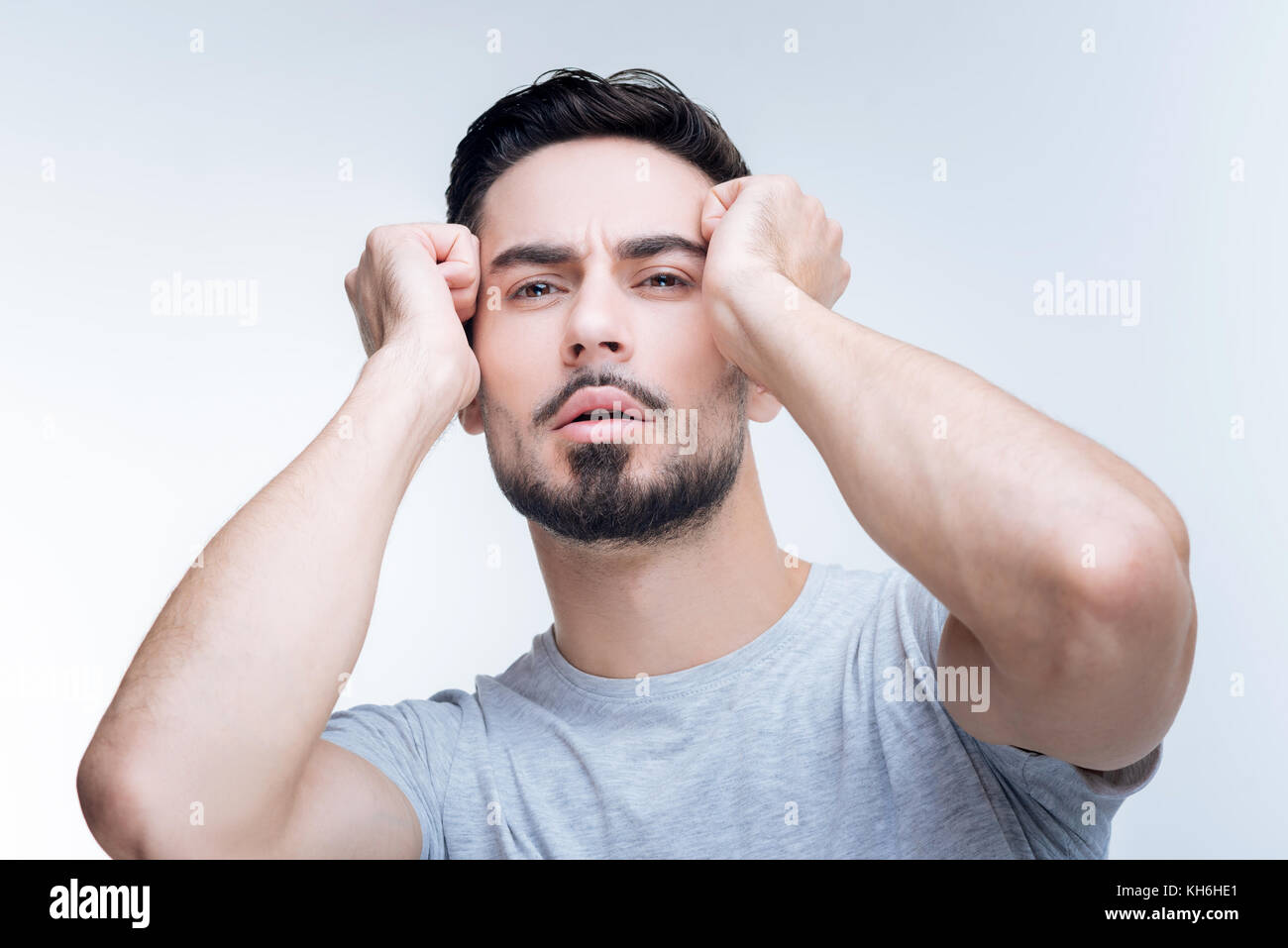 Sad strong young man looking into the distance Stock Photo - Alamy