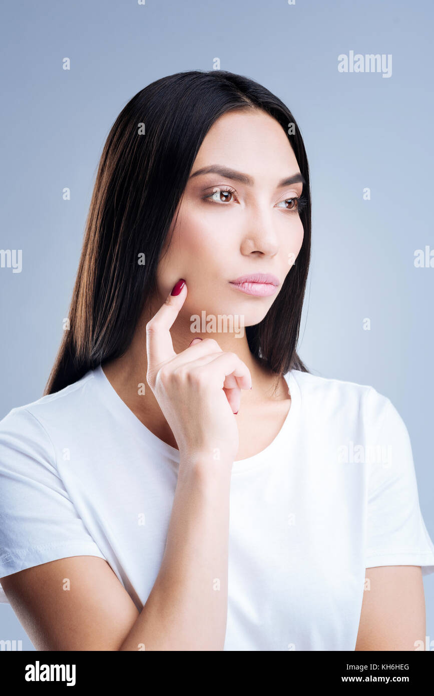Beautiful elegant woman touching her right chick Stock Photo - Alamy