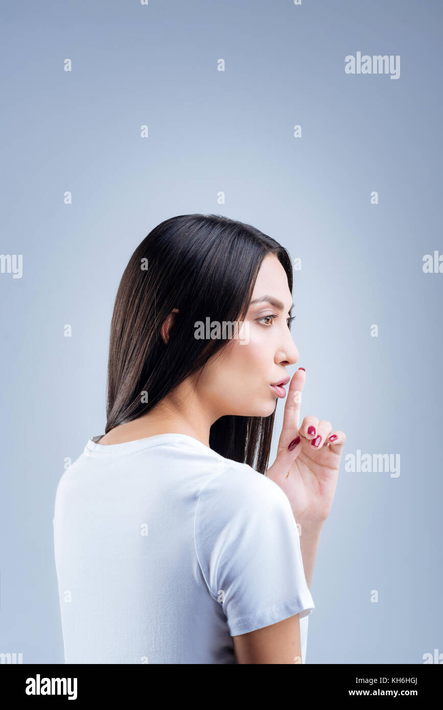 Kind attentive mother asking her children to be quiet Stock Photo - Alamy