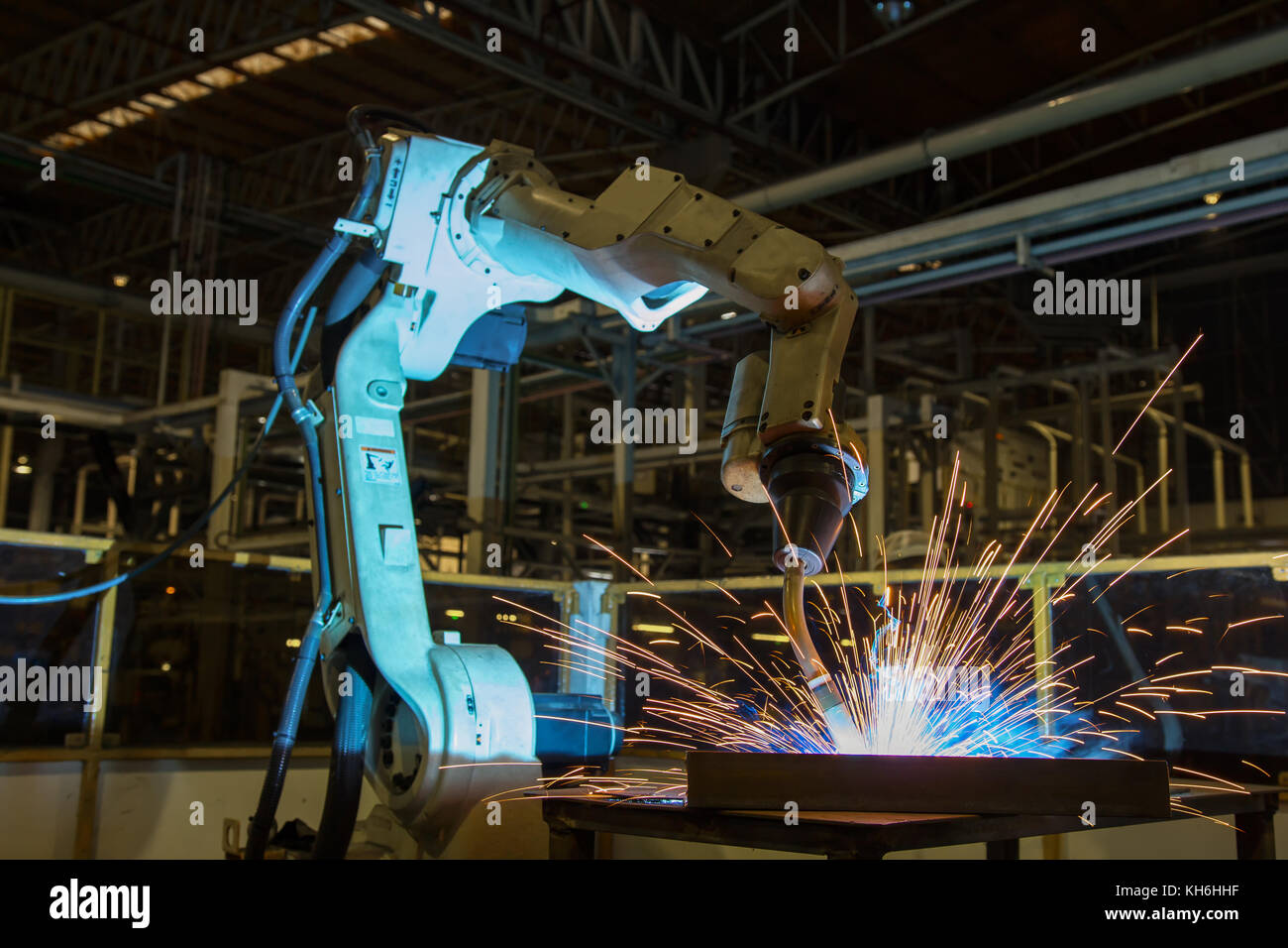 Robot is welding metal part in car factory Stock Photo - Alamy