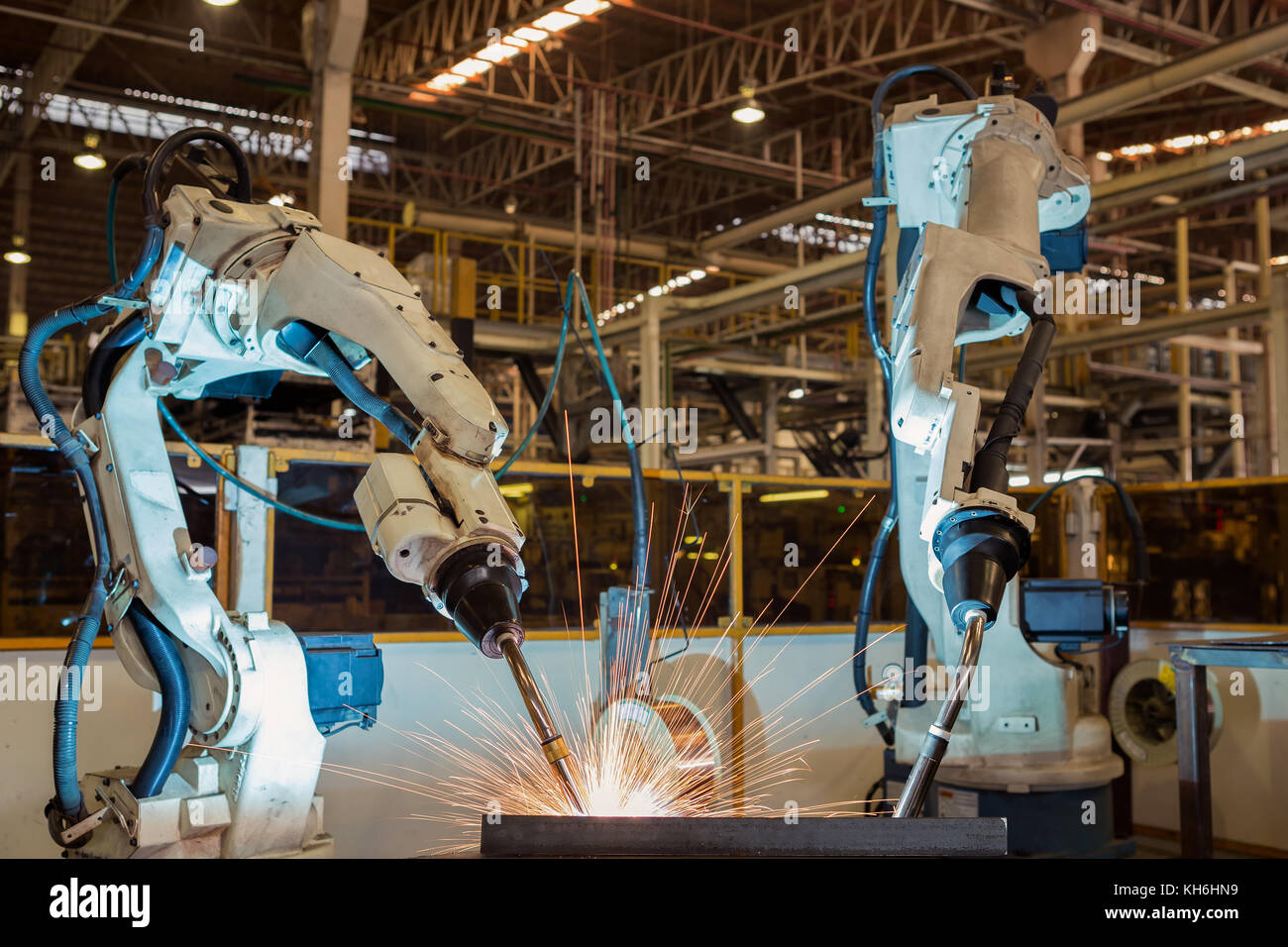Industrial welding robots in production line manufacturer factory Stock ...