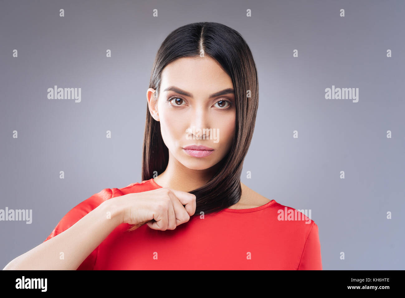 Calm young woman showing the condition of her long beautiful hair Stock ...