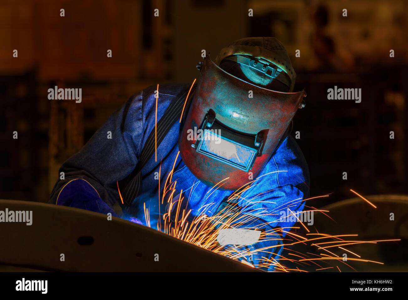 Industrial worker is welding in factory Industrial worker is welding in ...