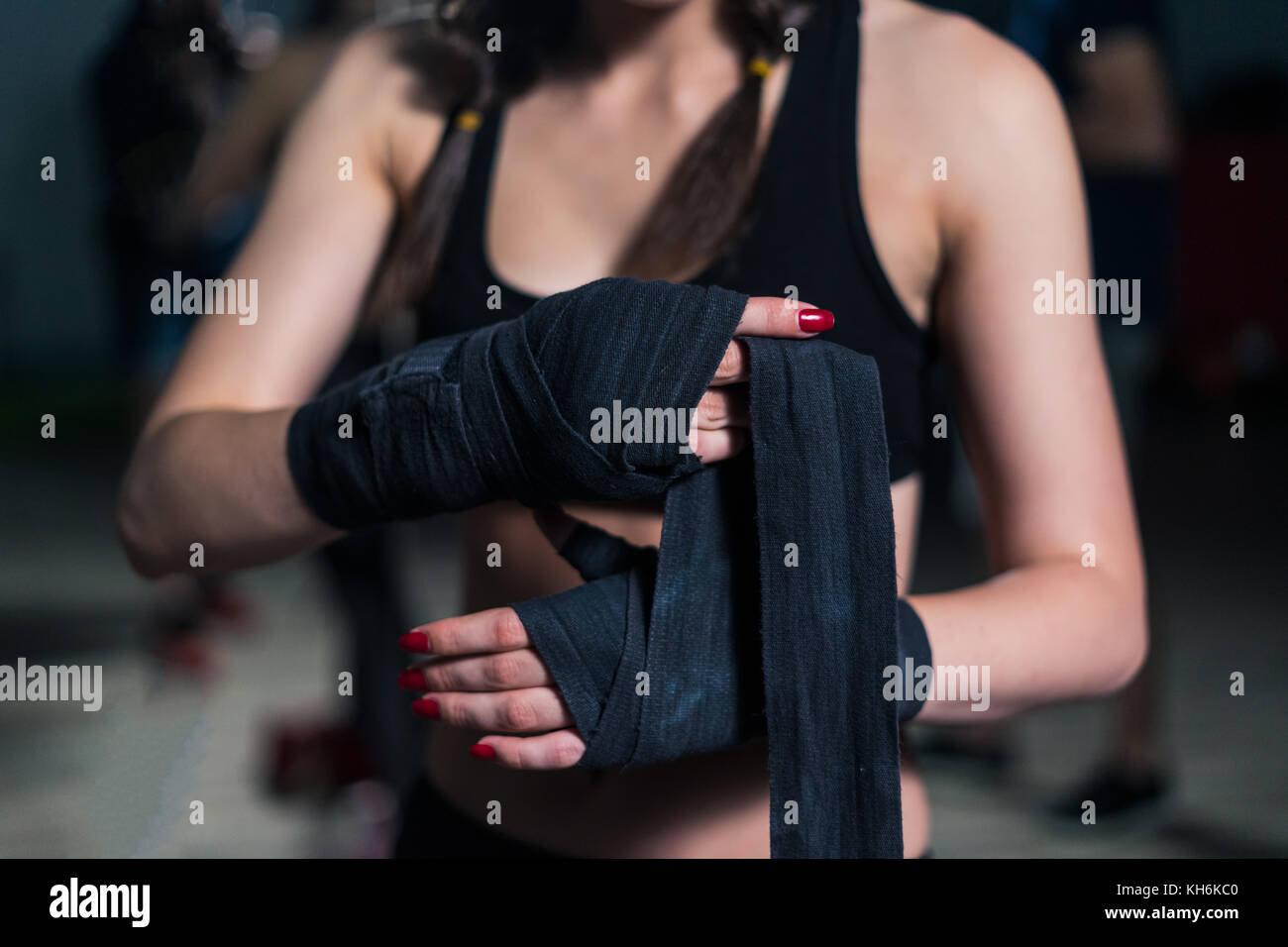 Young fighter boxer girl putting on hand bandage Stock Photo - Alamy