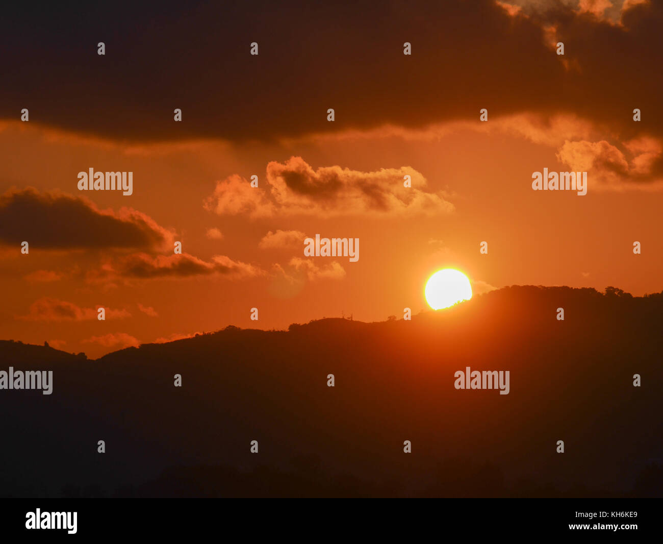 Sunset behind mountain And the evening sky Stock Photo - Alamy