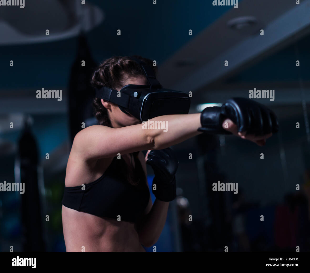 Young fighter boxer fit girl in VR glasses wearing boxing gloves Stock ...