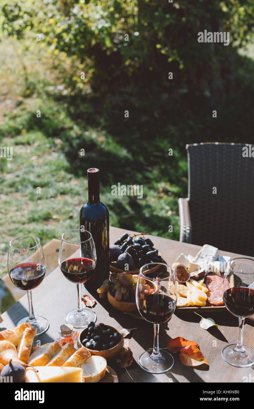 table with red wine and snacks Stock Photo - Alamy