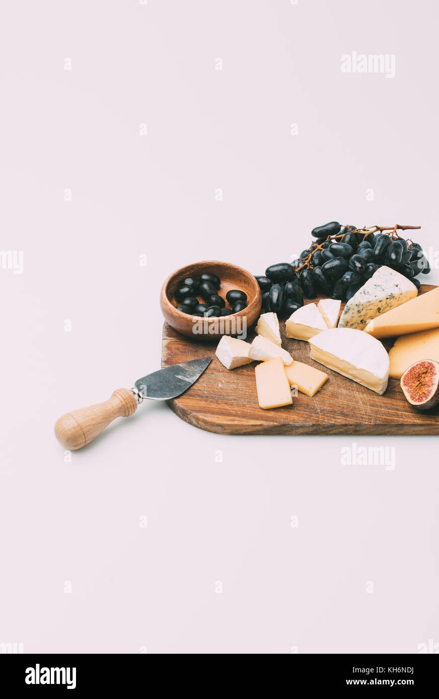 snacks for wine on cutting board Stock Photo - Alamy