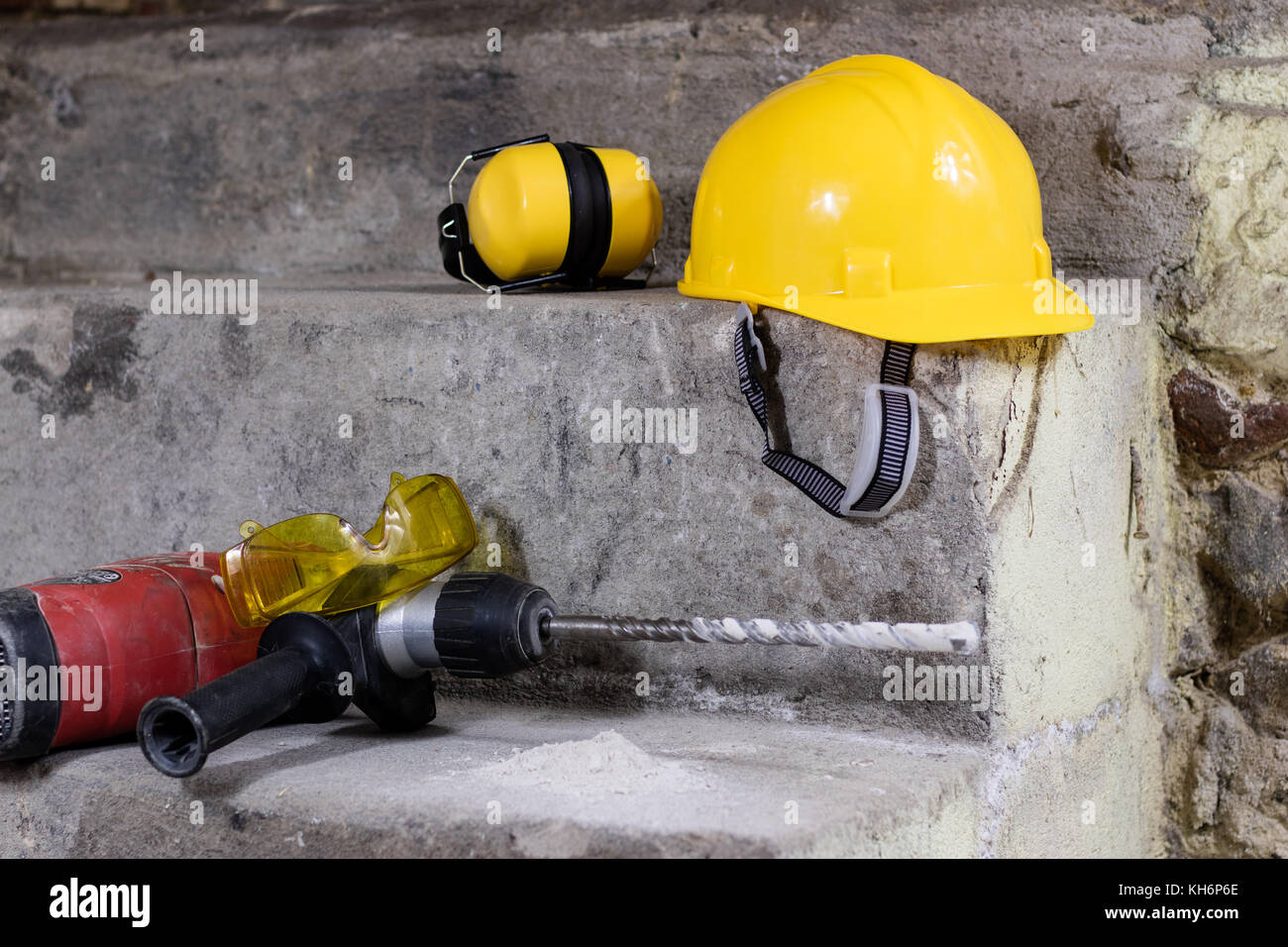 Demolition of walls. Electric hammer helmet and hearing protection ...