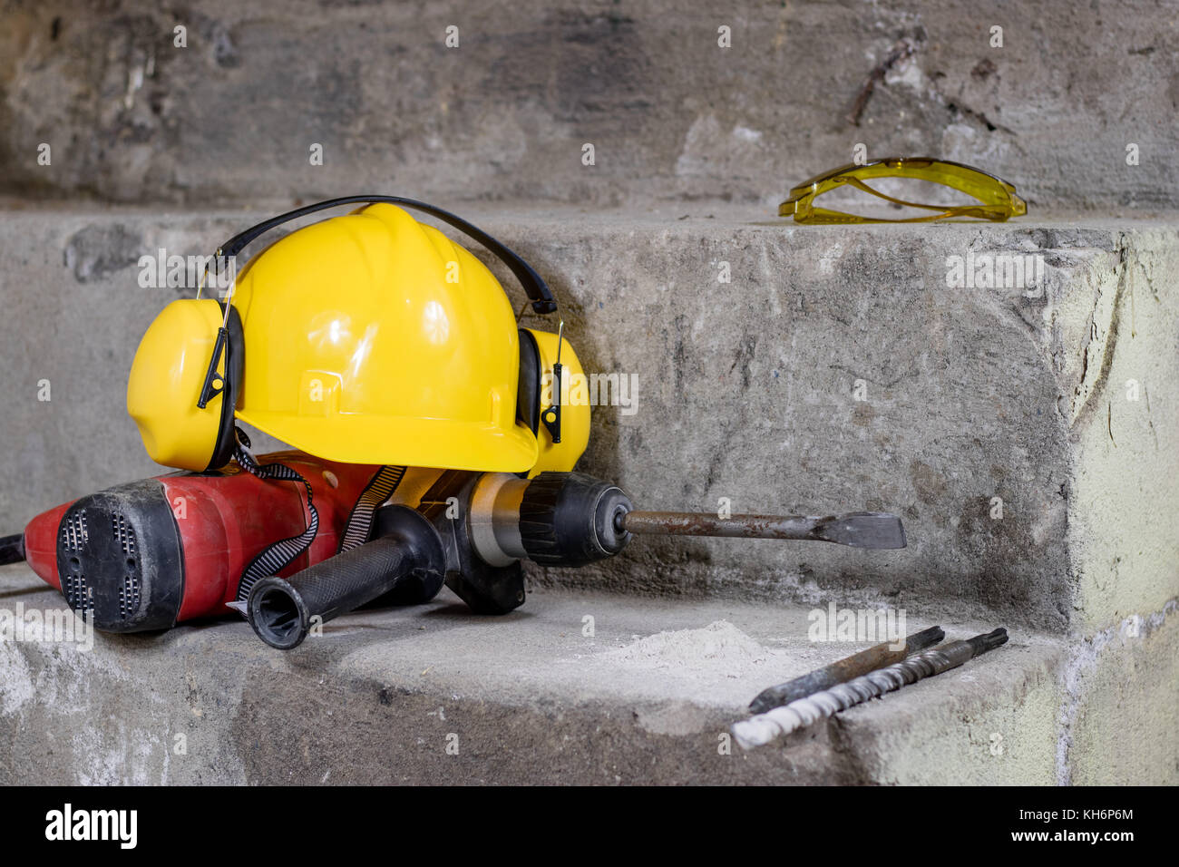 Demolition of walls. Electric hammer helmet and hearing protection ...