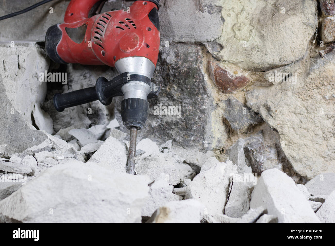 Demolition of walls. Electric hammer helmet and hearing protection ...