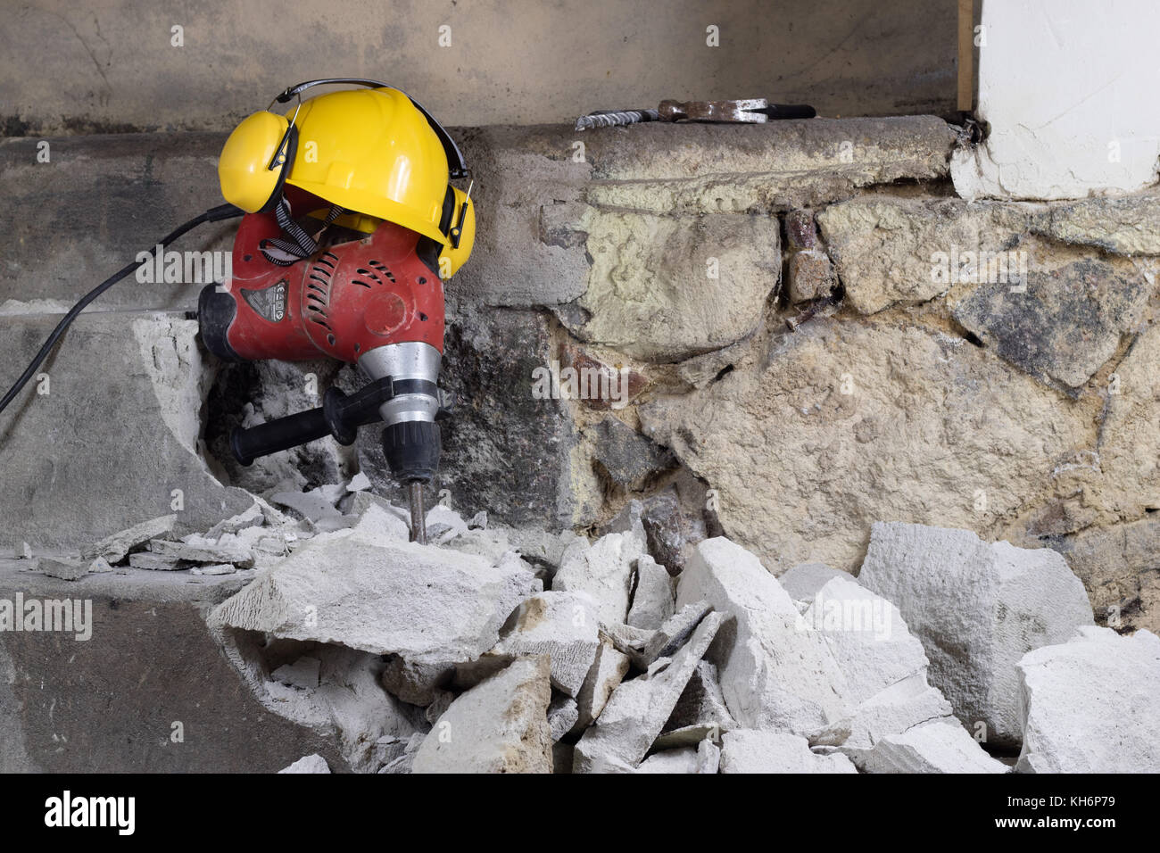Demolition of walls. Electric hammer helmet and hearing protection ...