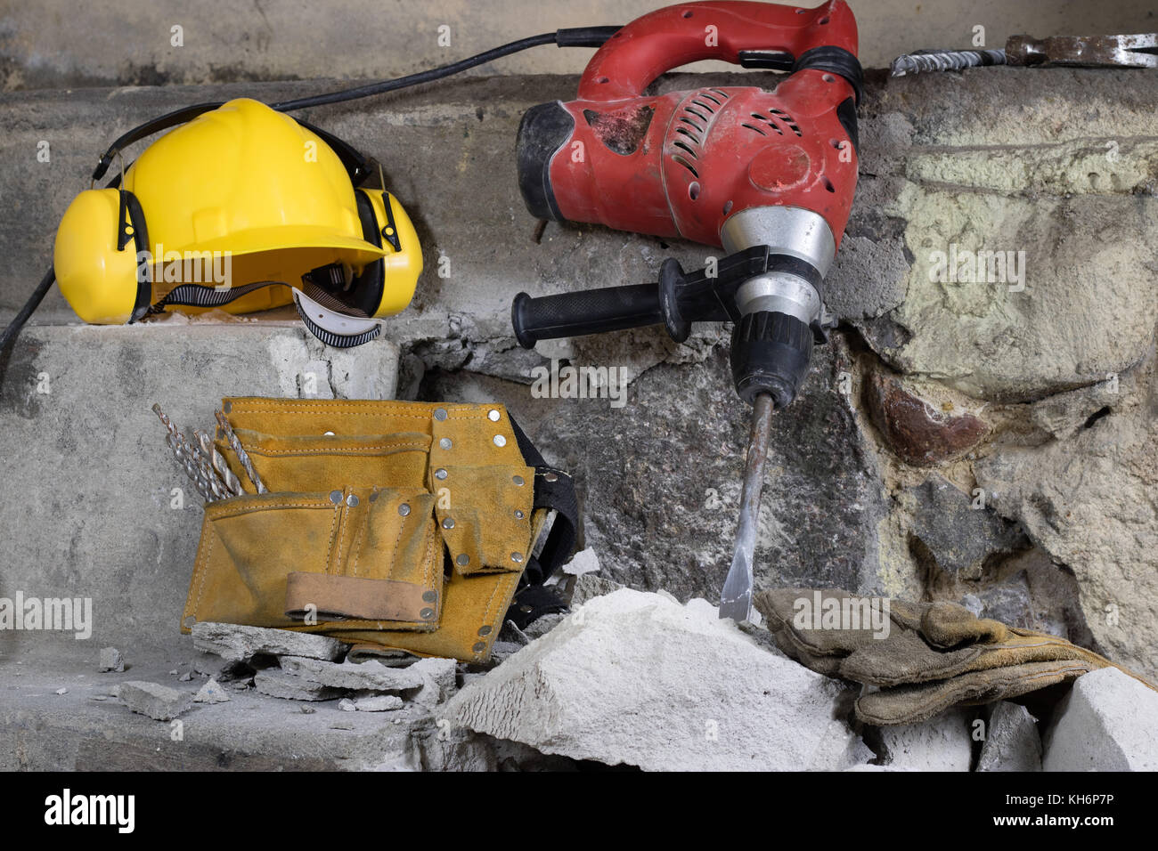 Demolition of walls. Electric hammer helmet and hearing protection ...