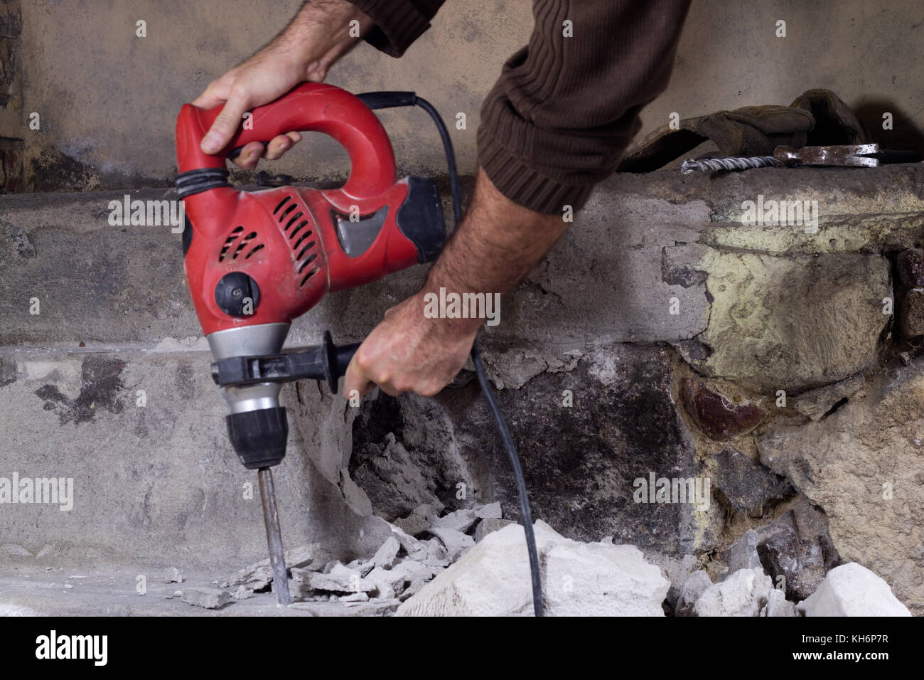 Demolition of walls. Electric hammer helmet and hearing protection ...
