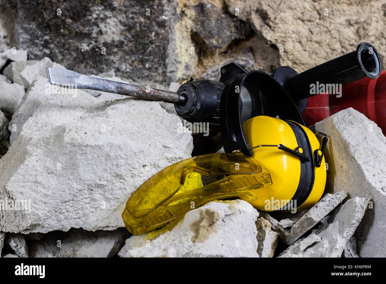 Demolition of walls. Electric hammer helmet and hearing protection ...