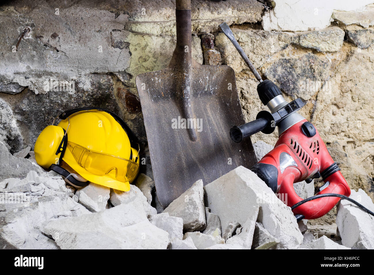 Demolition of walls. Electric hammer helmet and hearing protection ...