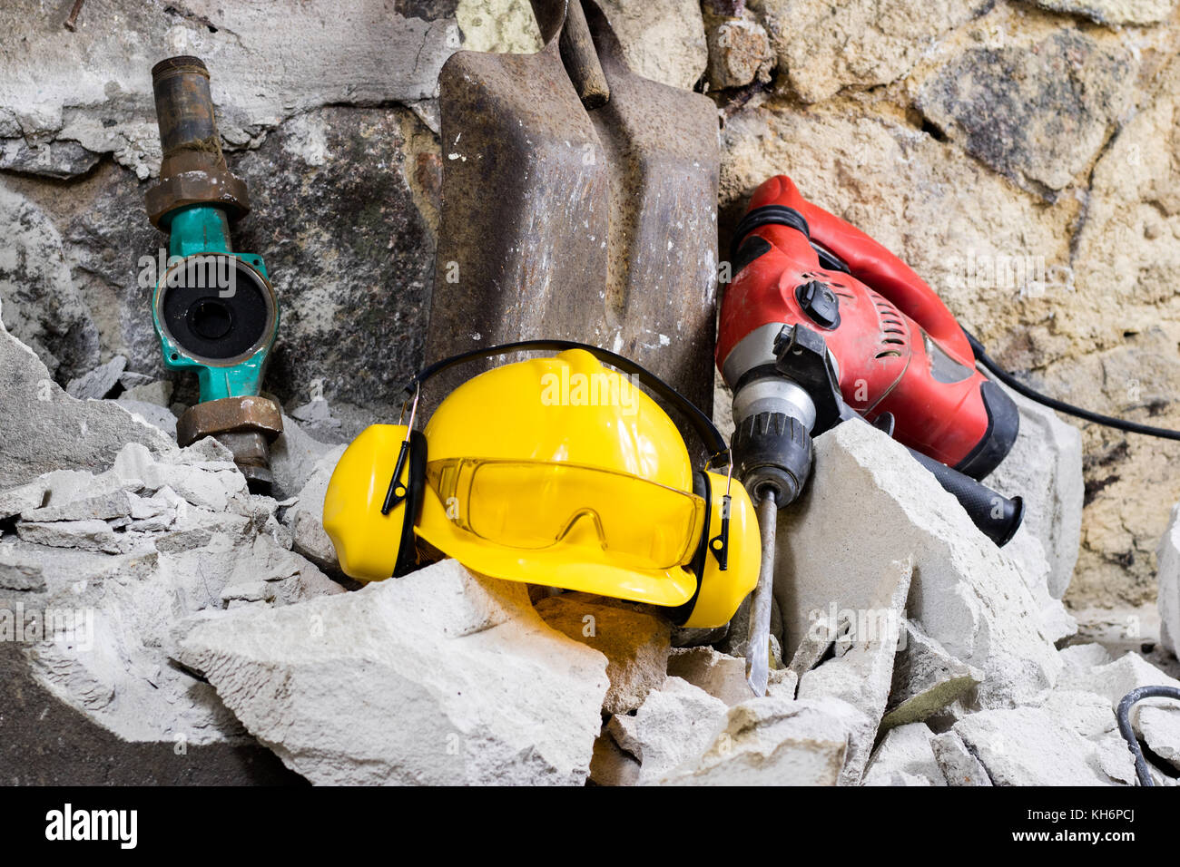 Demolition of walls. Electric hammer helmet and hearing protection ...