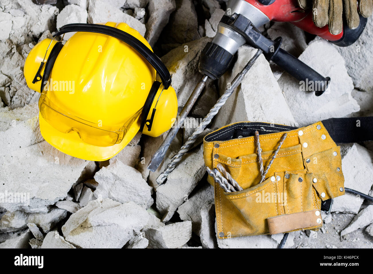 Demolition of walls. Electric hammer helmet and hearing protection ...