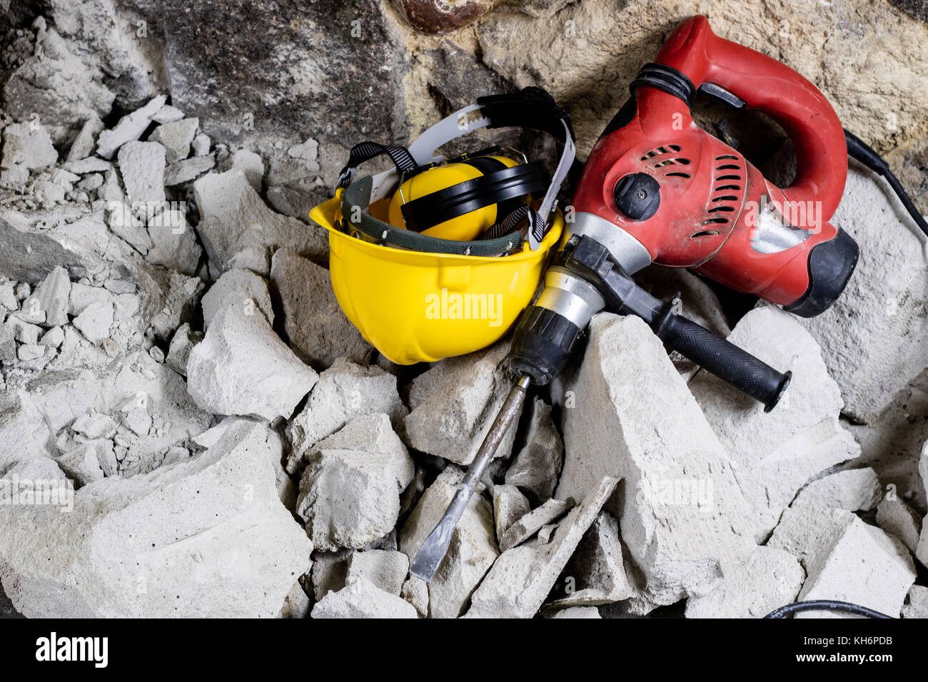 Demolition of walls. Electric hammer helmet and hearing protection ...