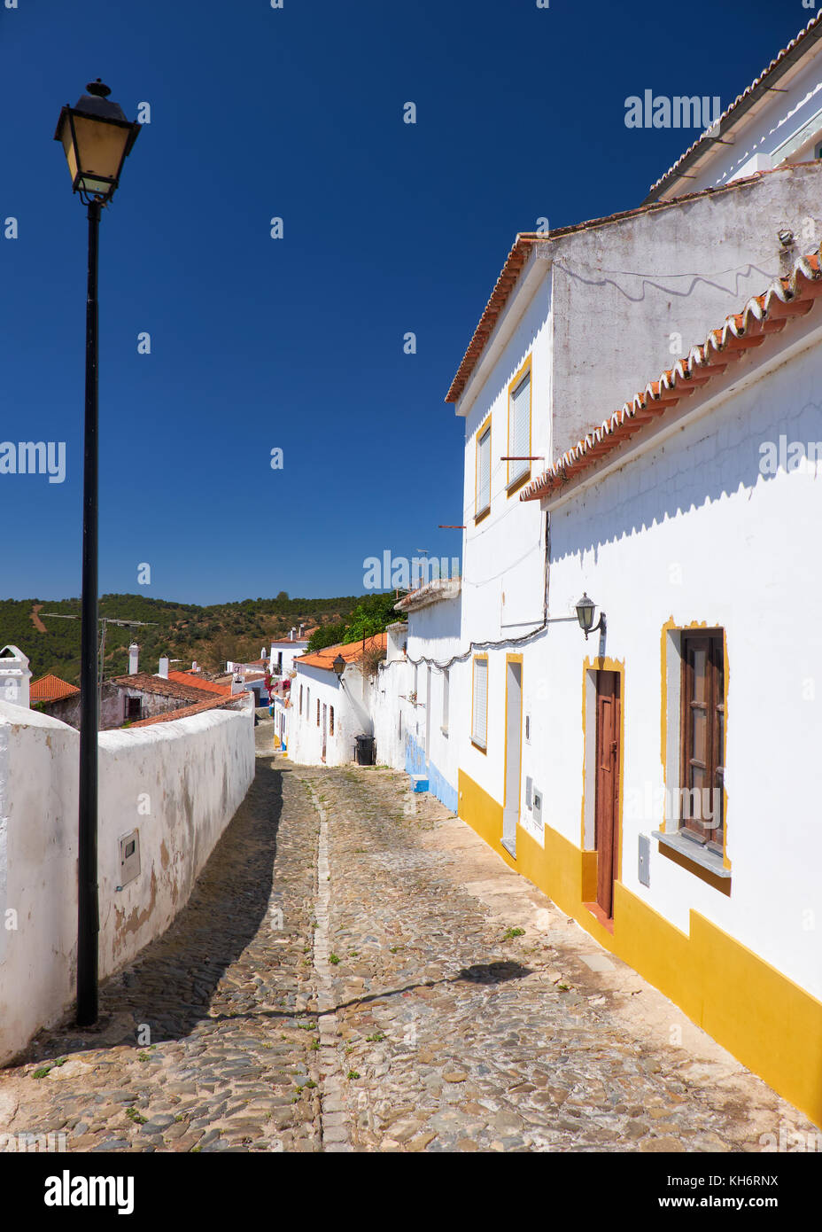 The cozy narrow paved streets with white Alentejo country-style houses ...