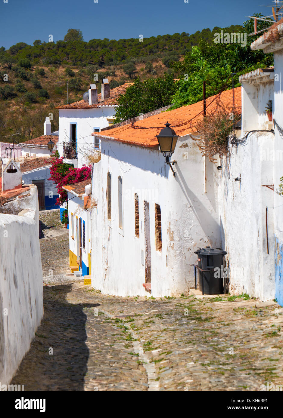 The cozy narrow paved streets with white Alentejo country-style houses ...