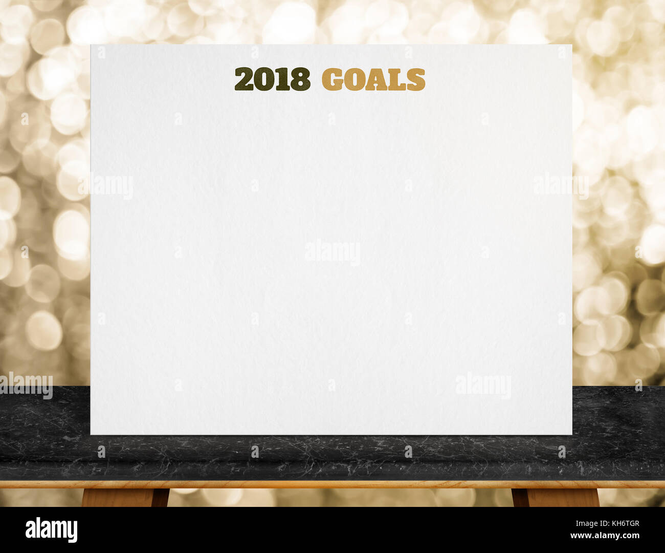 2018 goals on white paper poster on black marble table with gold bokeh ...