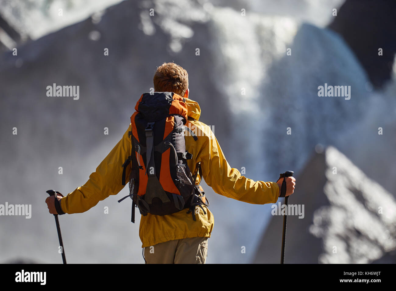 Hiker hiking with backpack looking at waterfall in park in beautiful ...