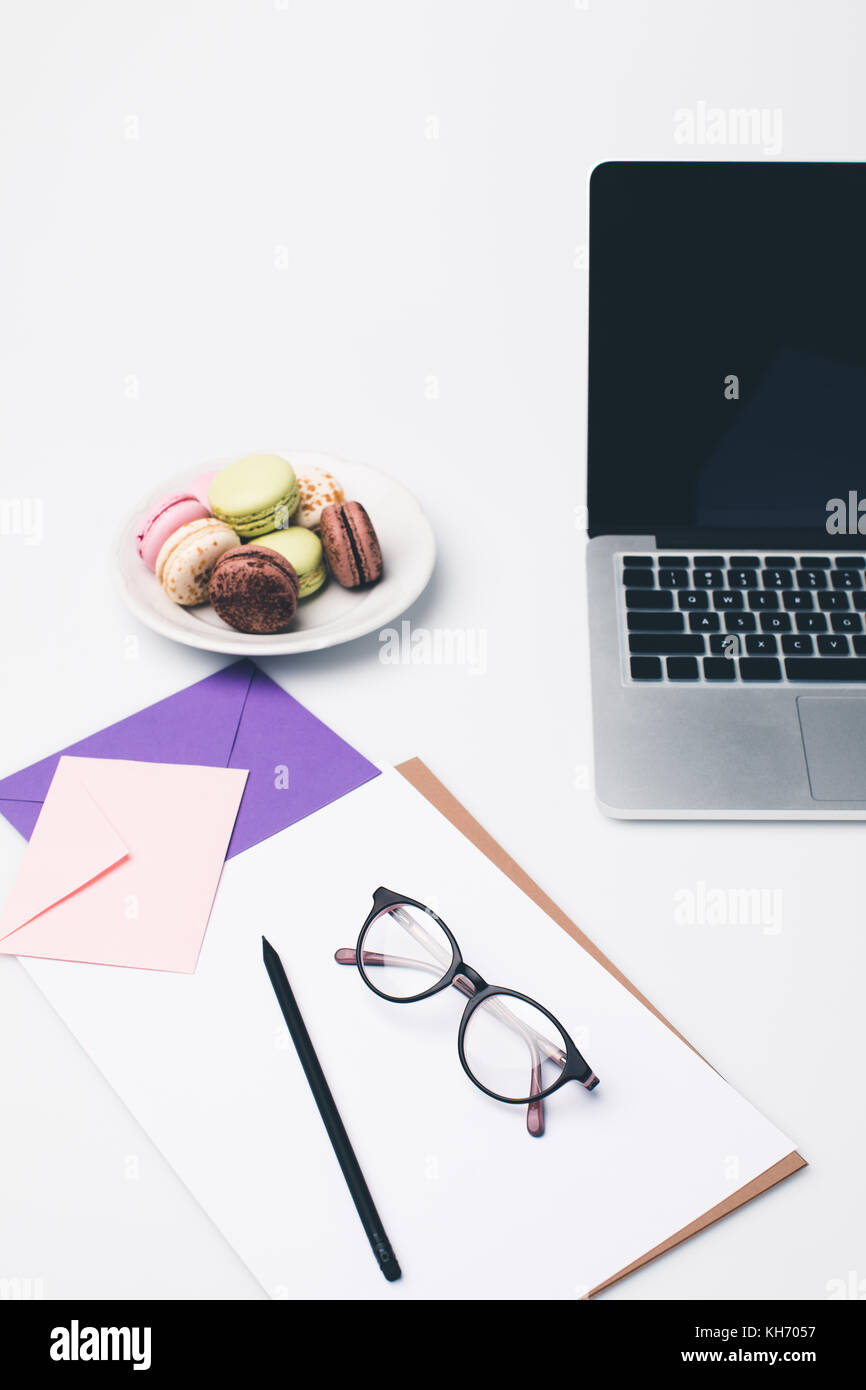 workplace with laptop and macaroons Stock Photo - Alamy
