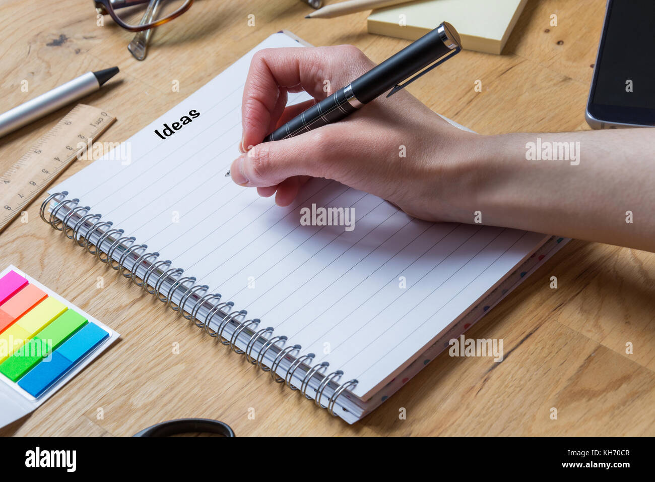 Person writing message on notepad hi-res stock photography and images ...