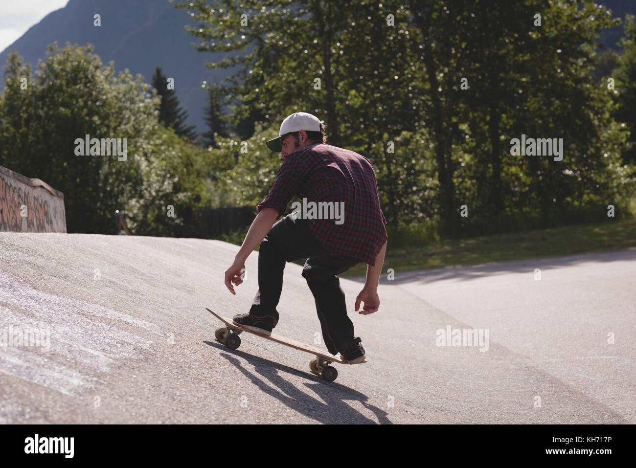 Man skating on skateboard in skate park on a sunny day Stock Photo - Alamy
