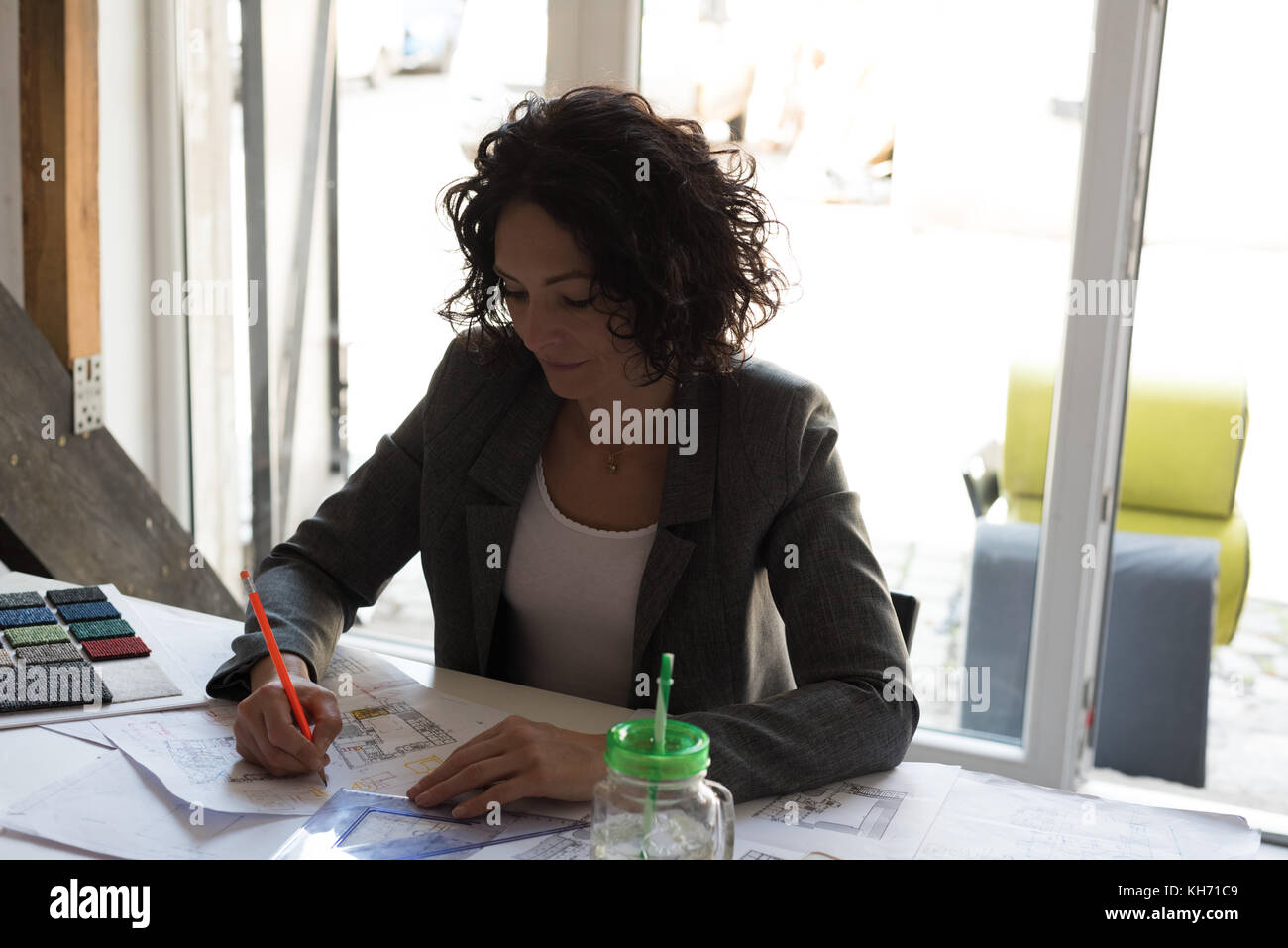 Beautiful female architect working in the office Stock Photo - Alamy