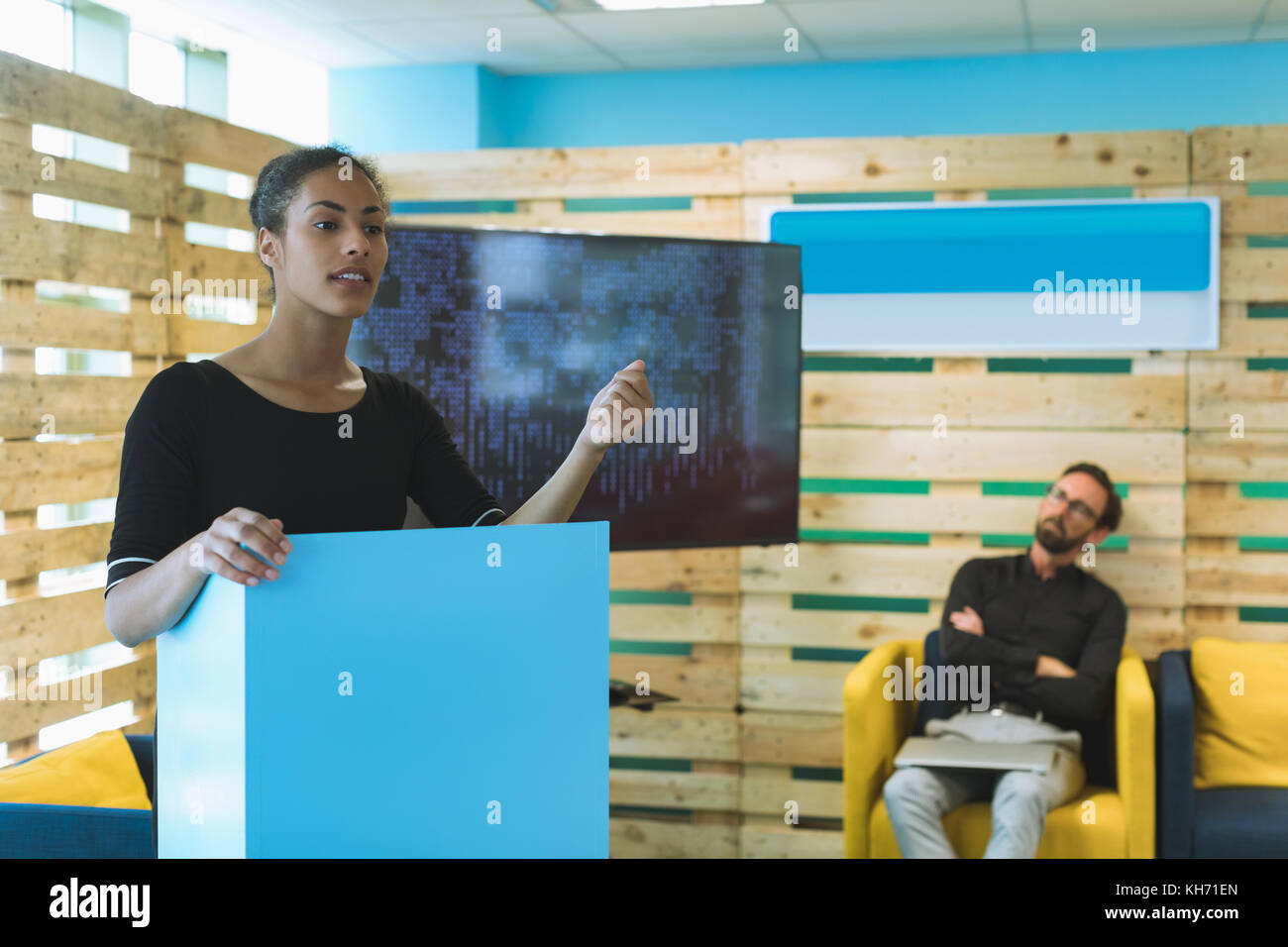 Confident female executive giving presentation in office Stock Photo ...