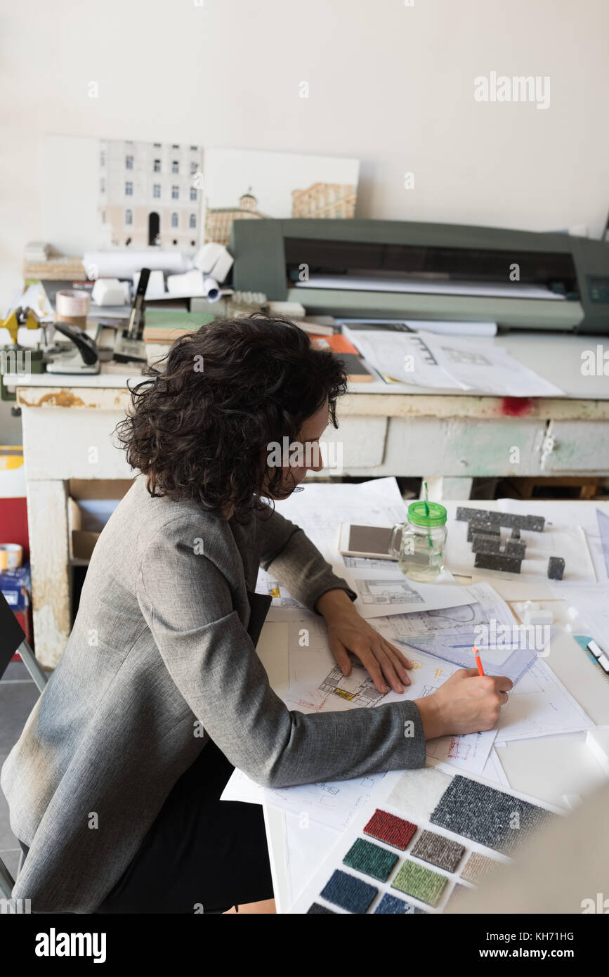 Beautiful female architect working in the office Stock Photo - Alamy