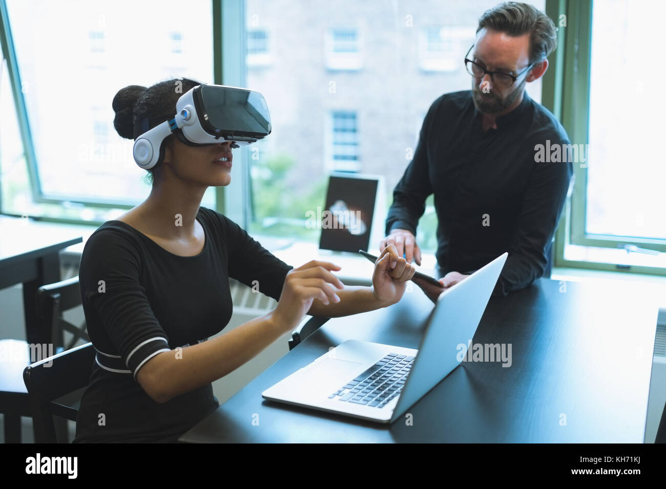 Executives working at table in office Stock Photo - Alamy