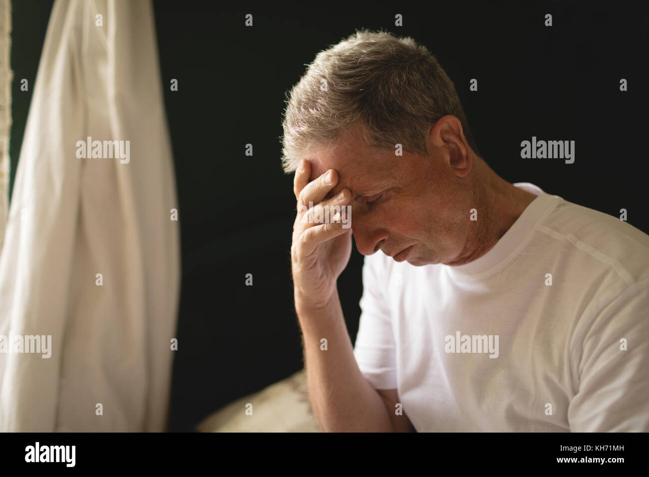 Worried senior man relaxing in bedroom at home Stock Photo - Alamy