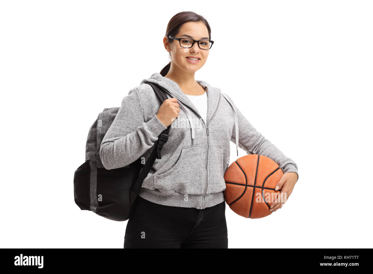 Teen girl with a backpack and a basketball isolated on white background ...