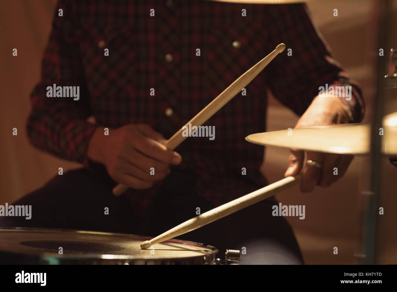 Mid section of drummer playing on drum set at studio Stock Photo - Alamy