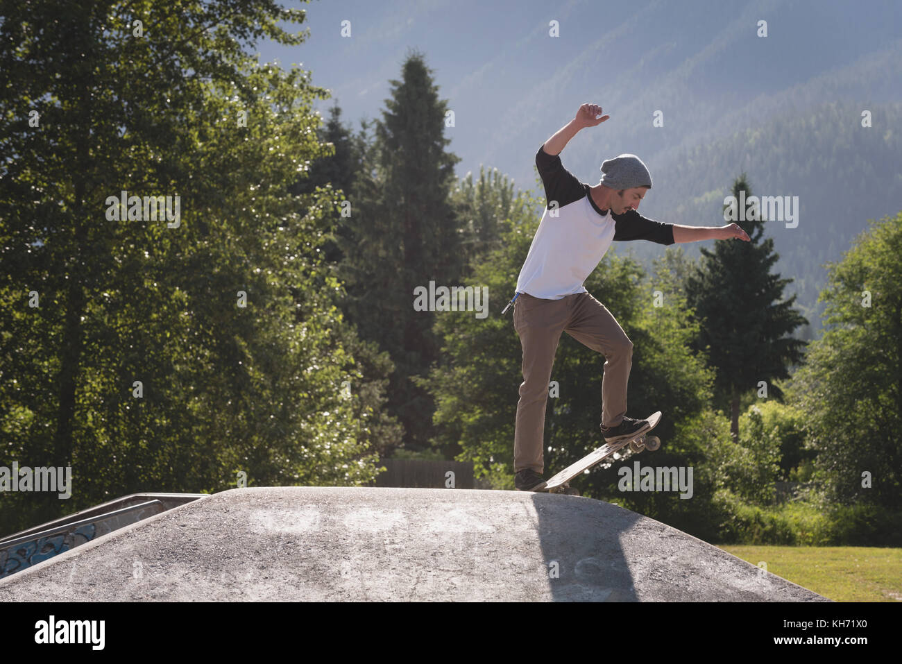 Skateboarder performing stunt on ramp in skate park Stock Photo - Alamy