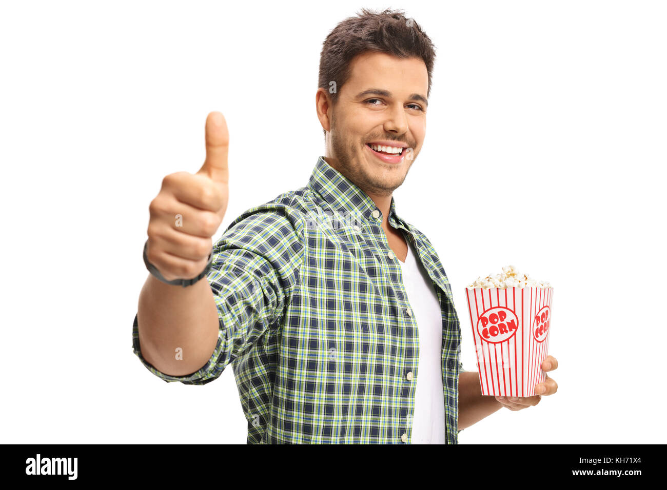 Young man with popcorn making a thumb up gesture isolated on white ...