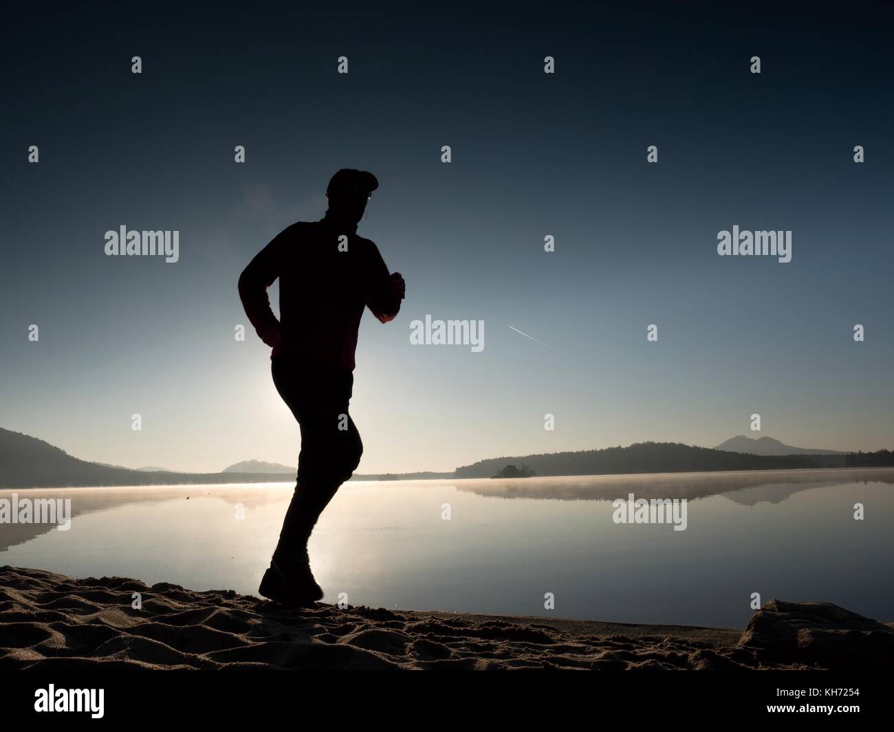 Running man. Boy quickly running on the morning beach. Sportsman runner ...