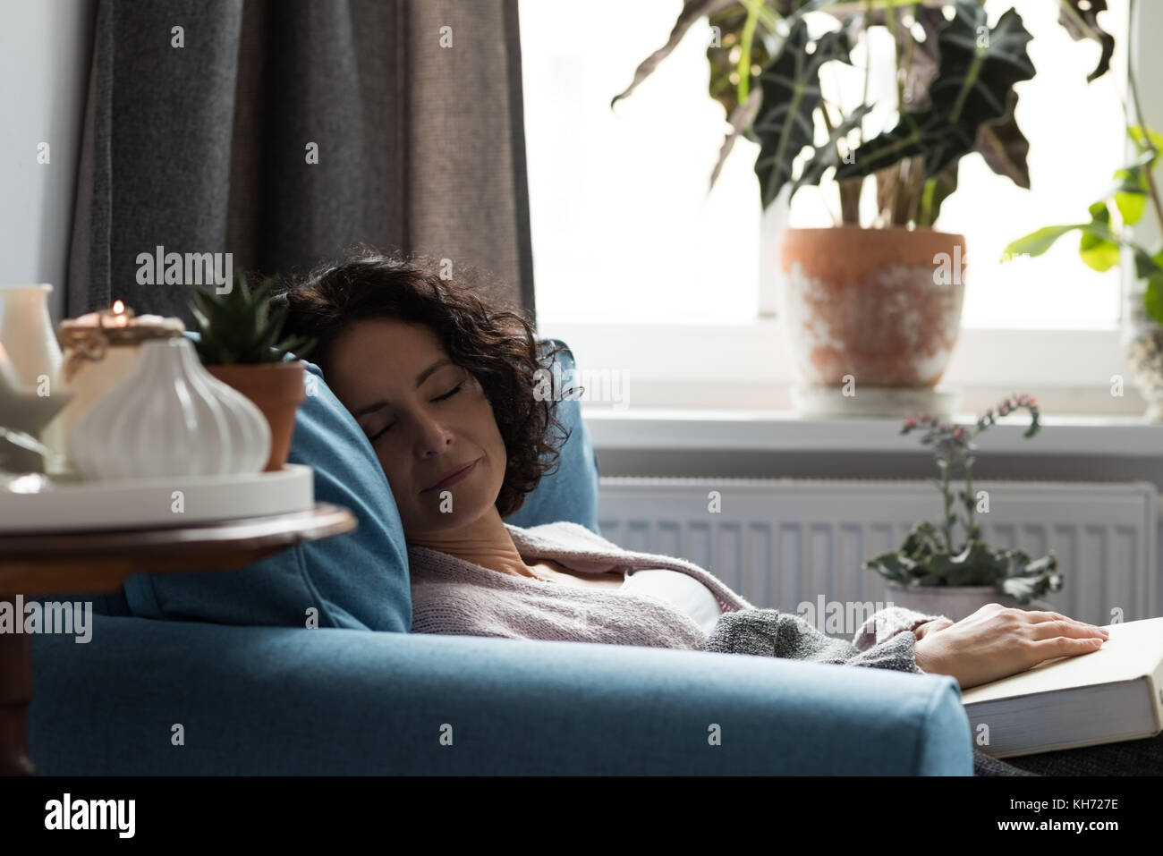 Beautiful woman resting on sofa at home Stock Photo - Alamy