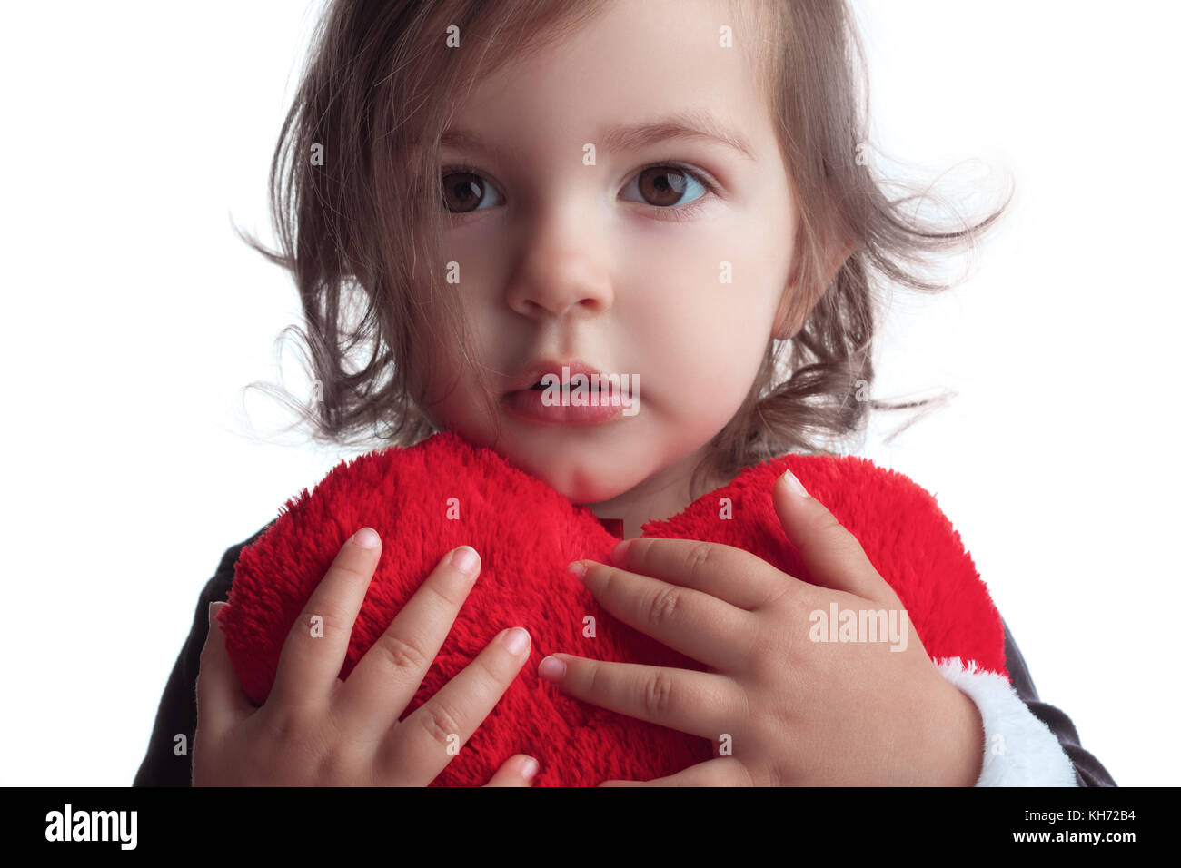 Cute little child girl portrait holding red heart toy on white ...