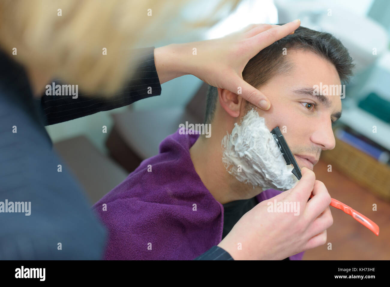 barber shaving mans chin with blade Stock Photo - Alamy