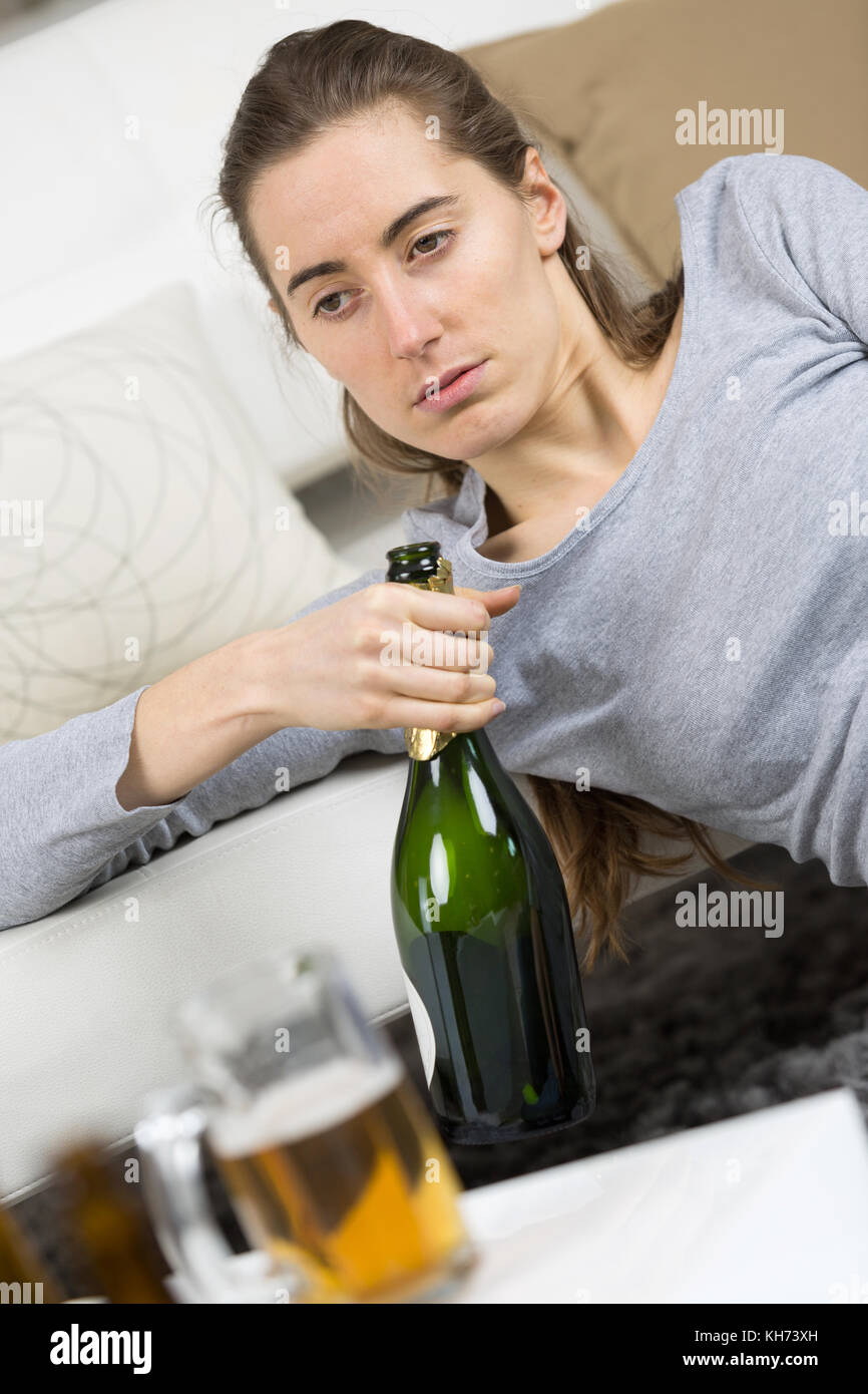 young drunken woman with bottle of wine Stock Photo - Alamy