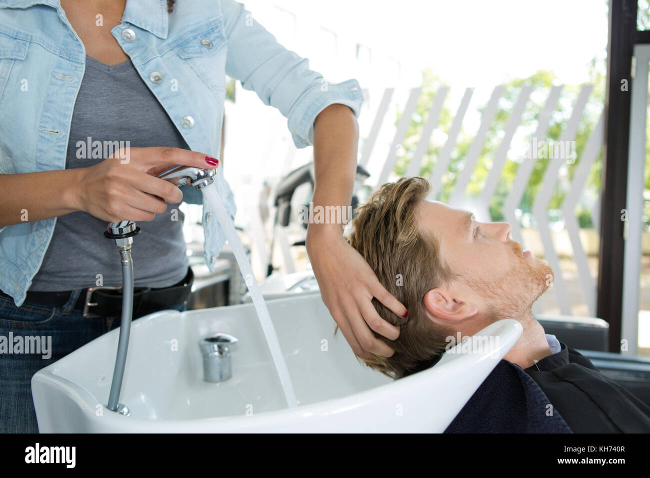 relaxed man having hair washed in beauty salon Stock Photo - Alamy