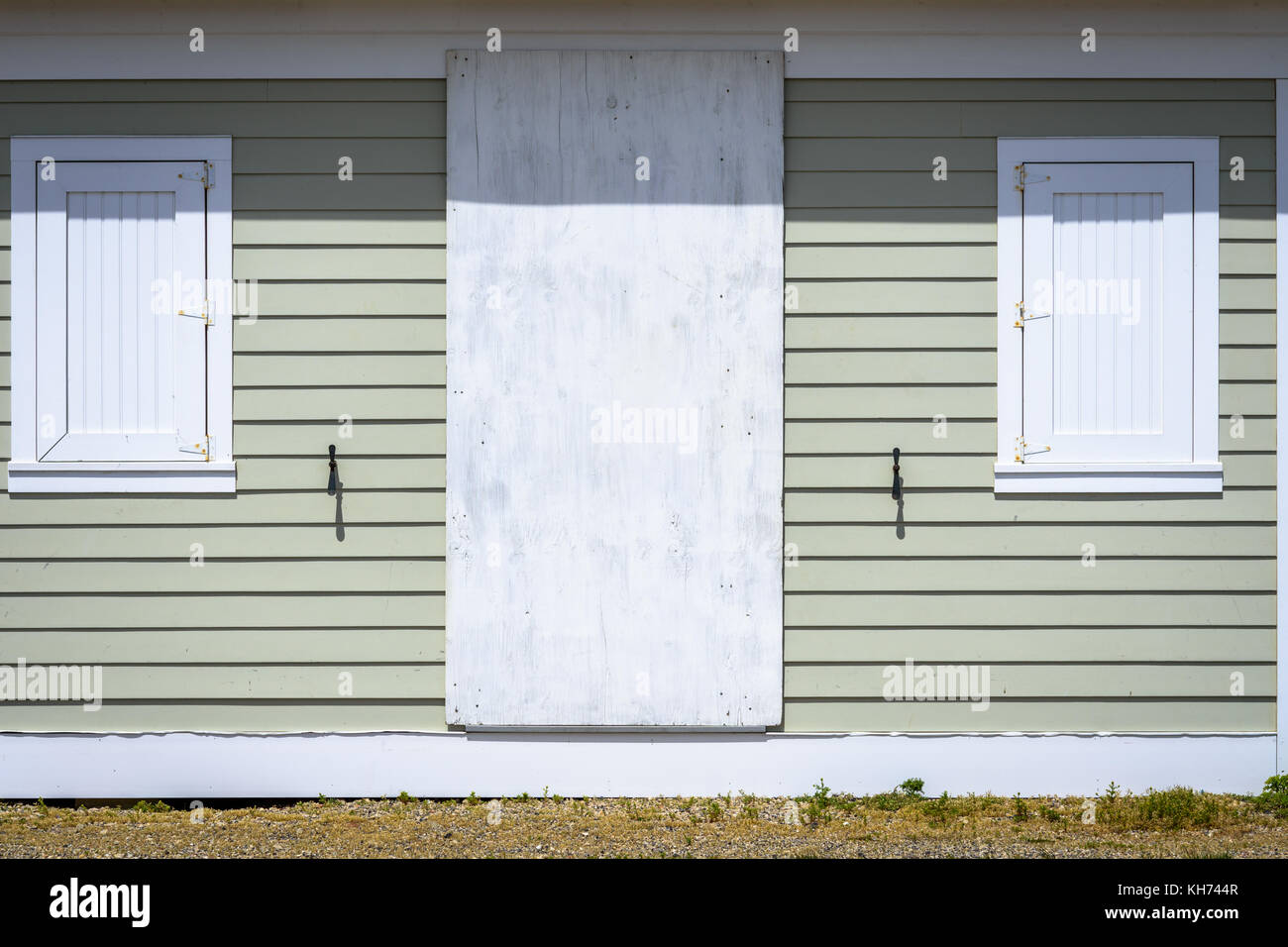 A beach shack with 2 windows and a door Stock Photo - Alamy